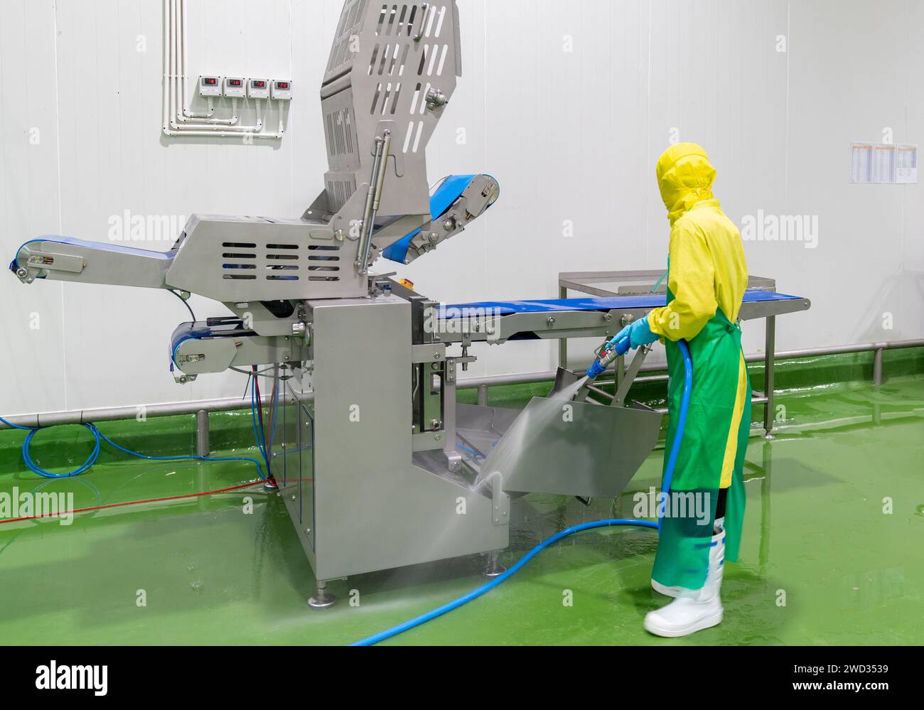 Worker use high pressure water spray cleaning machine after finishing ...