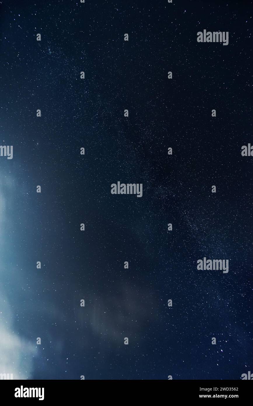 Night starry sky with clouds illuminated by moonlight. Night landscape ...
