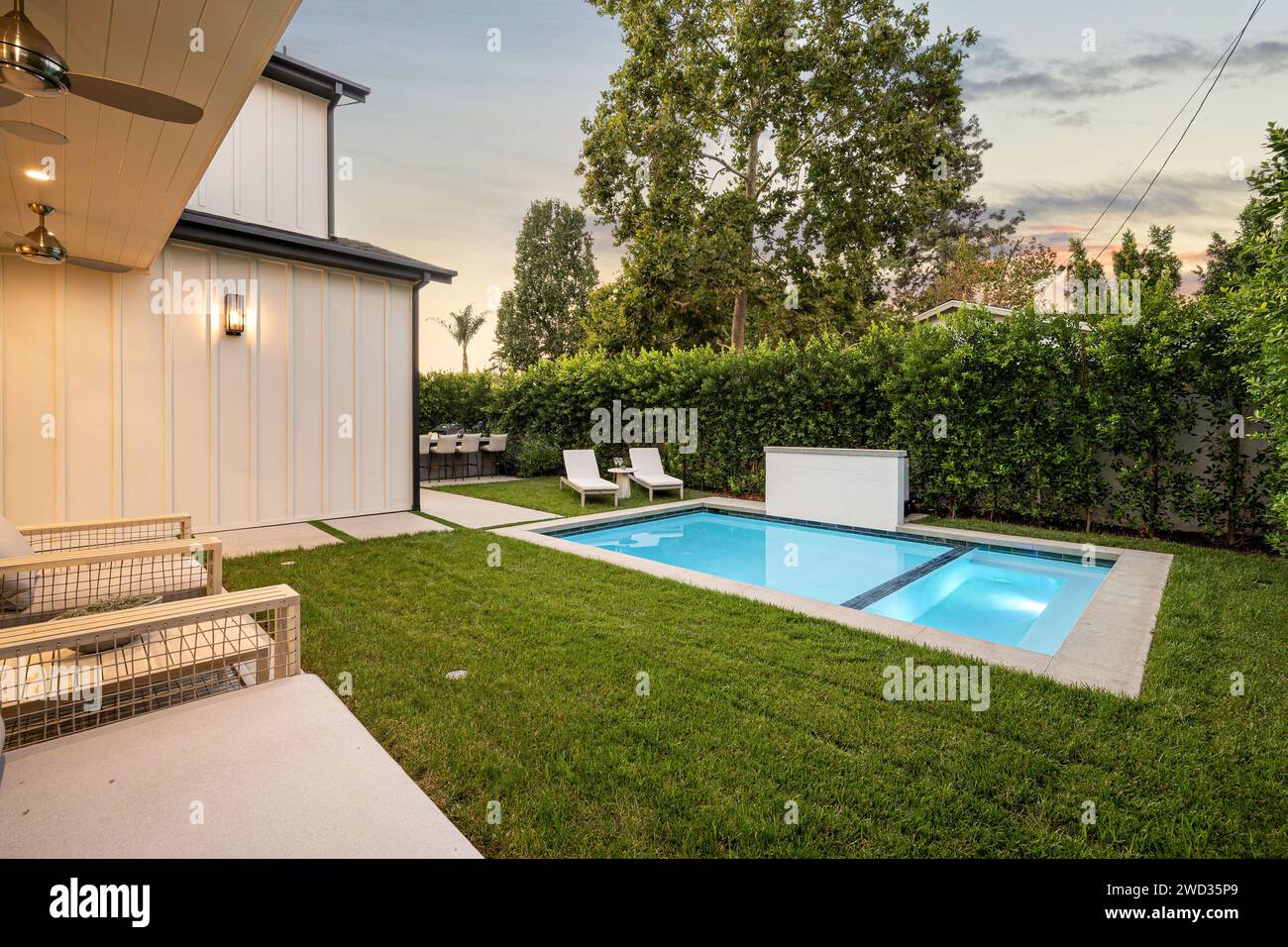 Backyard with inground pool and outdoor seating Stock Photo - Alamy