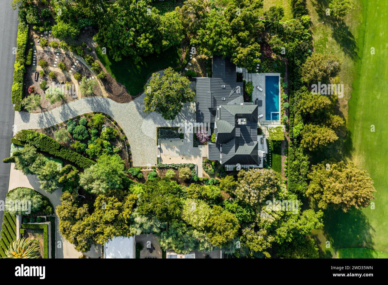 Aerial view of spacious residence with lush gardens and expansive front ...