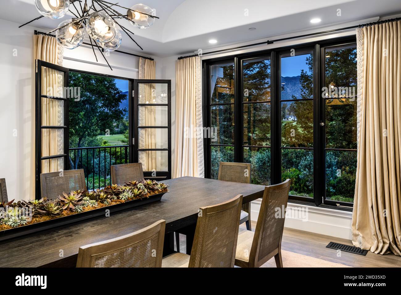 Table and chairs by a glass window Stock Photo - Alamy