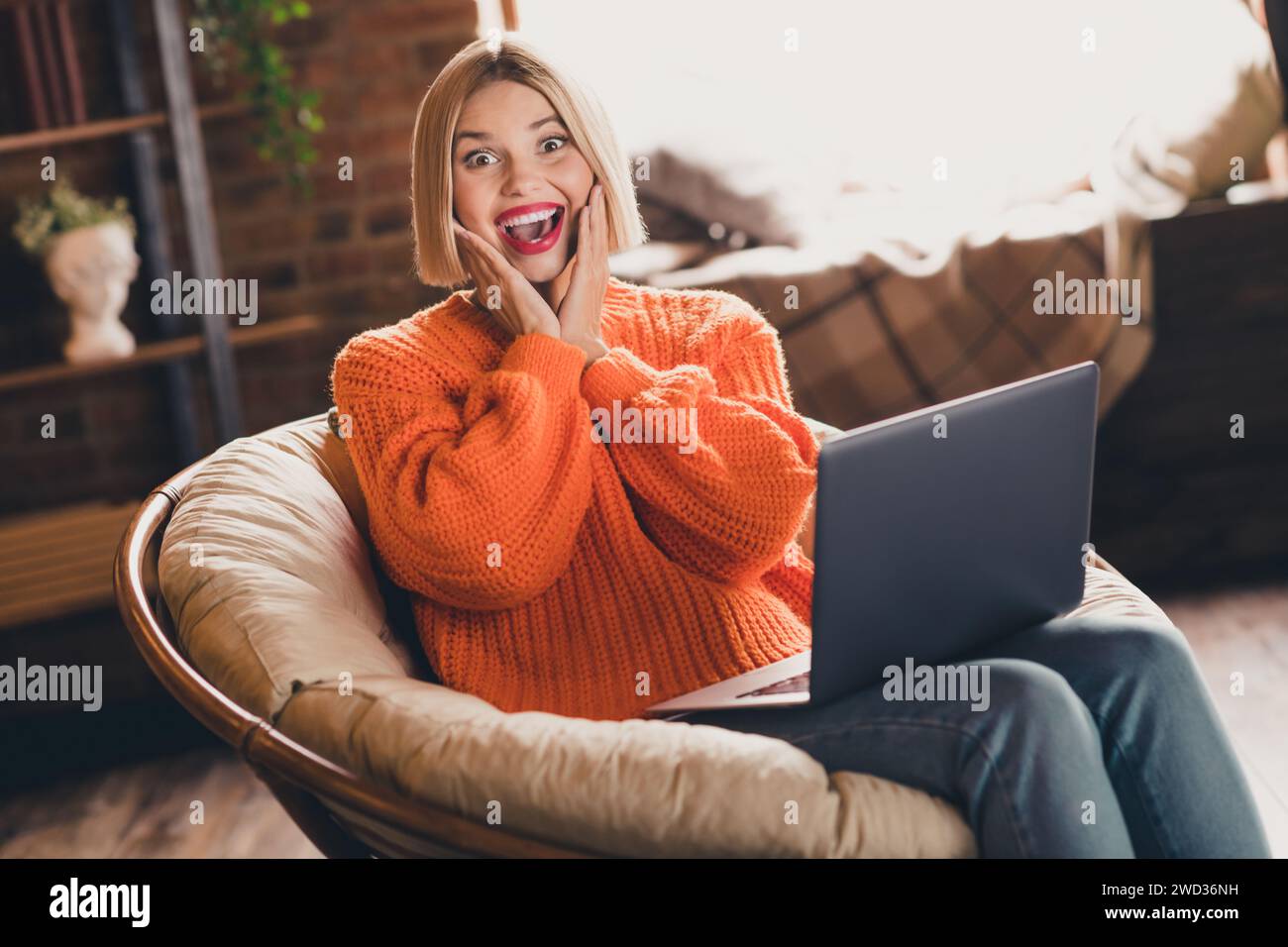 Photo of astonished pretty girl sit chair hands touch cheeks open mouth ...