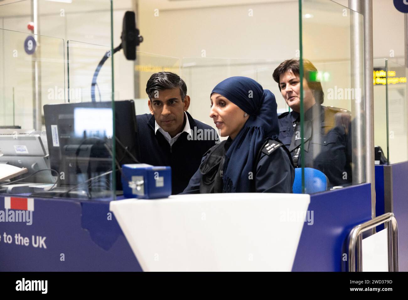 Rishi Sunak looks at the passport control unit next to Border Force ...