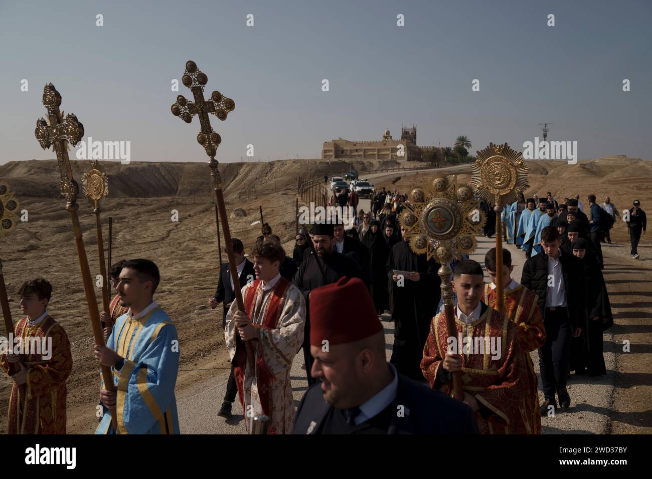 Greek Orthodox faithfuls take part in a procession towards the Jordan ...