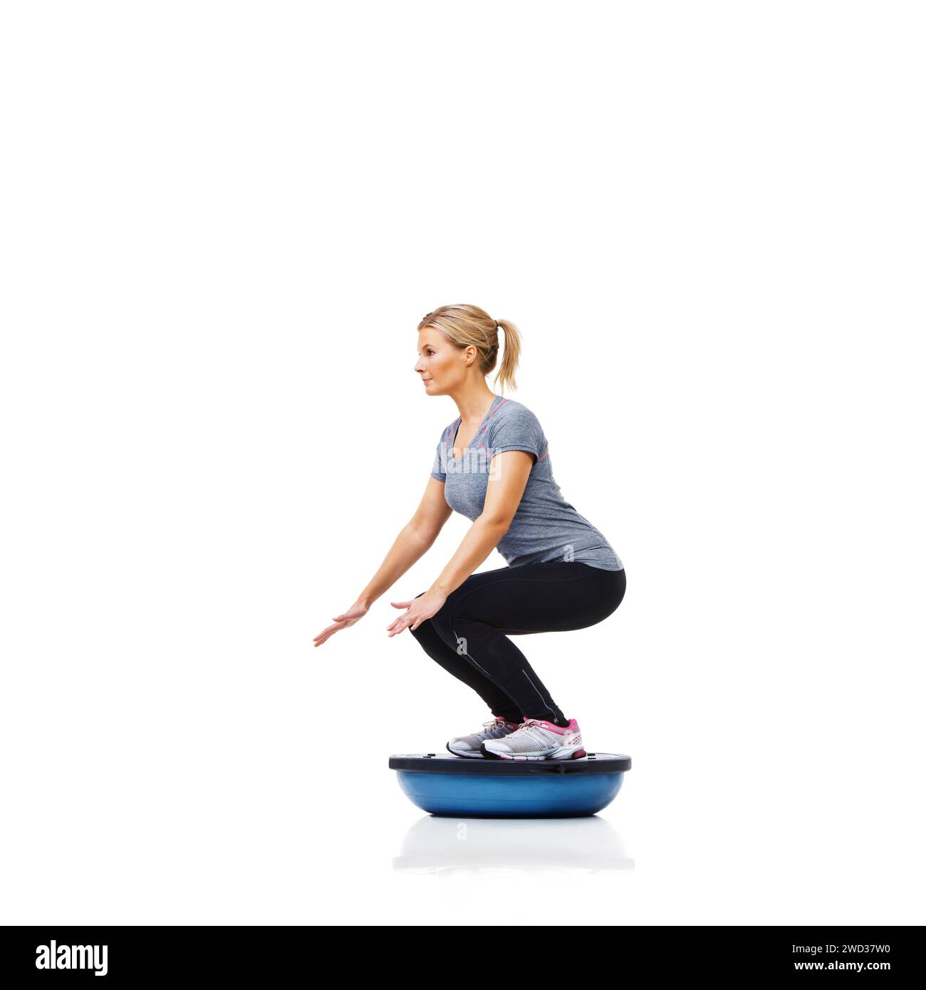 Woman, studio and squat with workout, ball or balance for legs, muscle ...