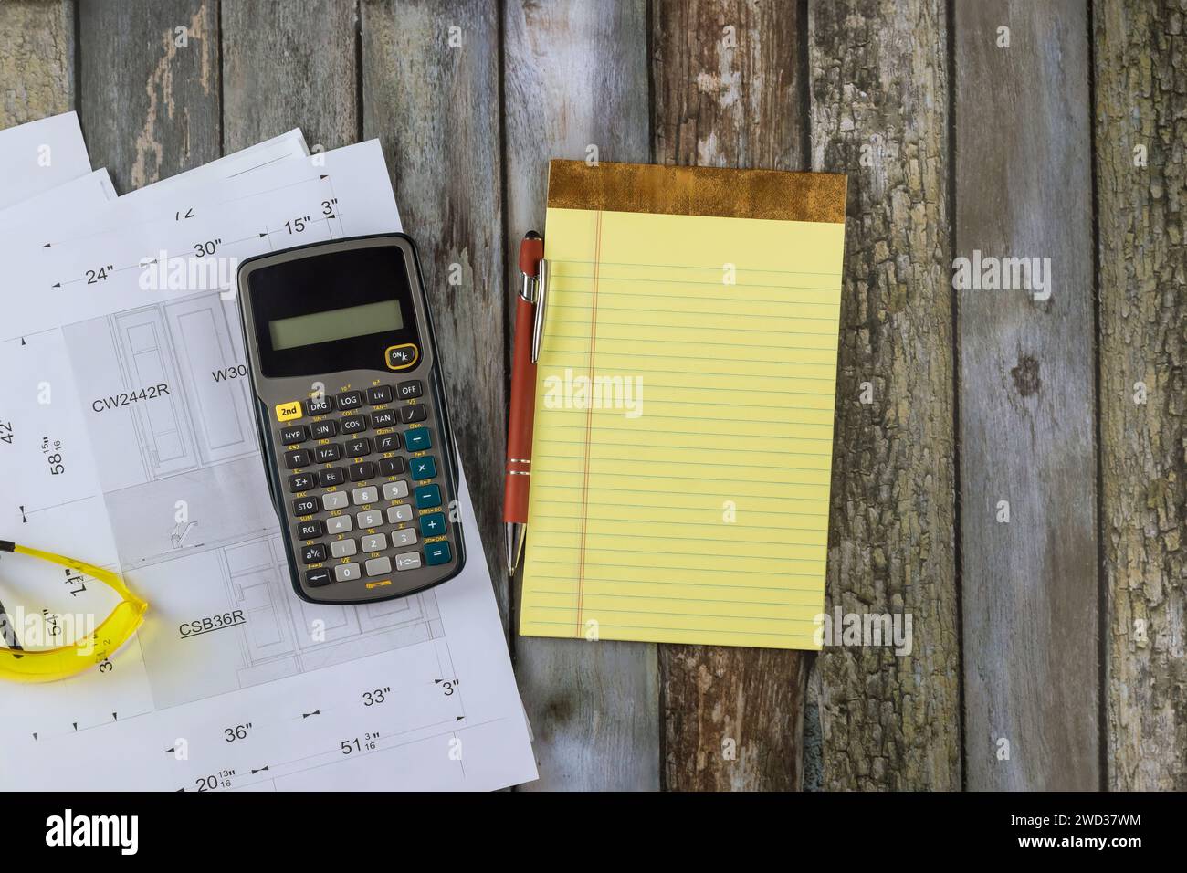 Plan for remodeling kitchen with cabinets plan is drawn on table by an ...