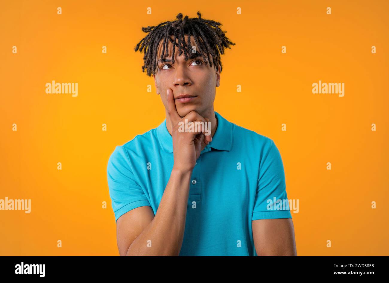 Thinking around man on yellow background. Smart student guy finding ...