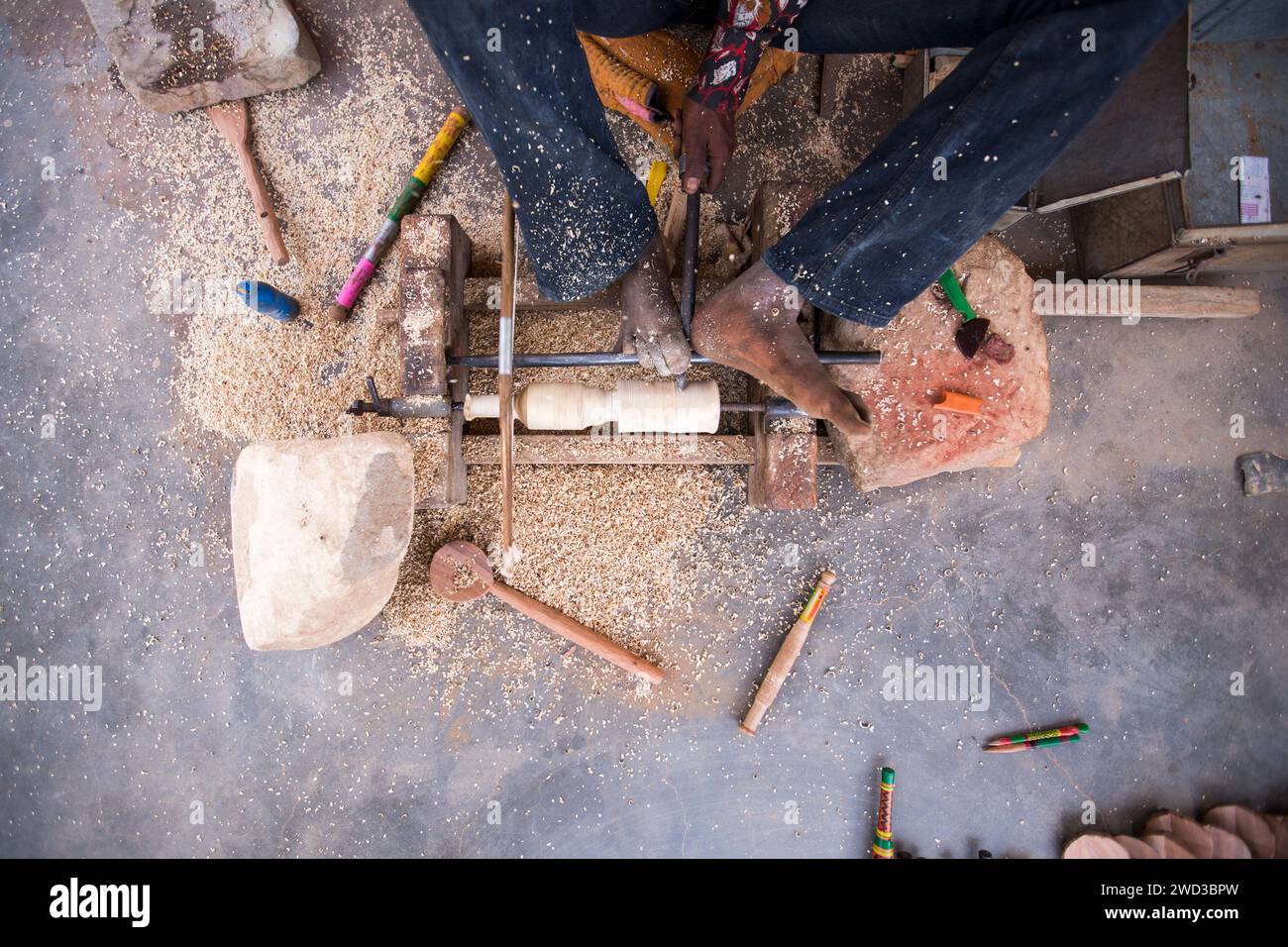 A skilled artisan meticulously cuts wood with a saw, transforming raw ...