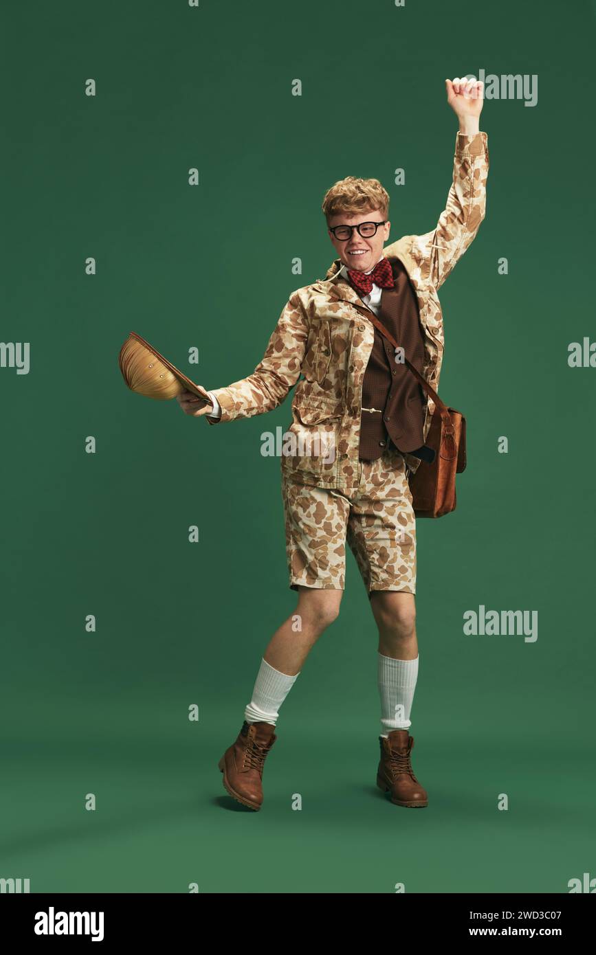 Full-length image of young guy in retro clothes in image of boy scout ...