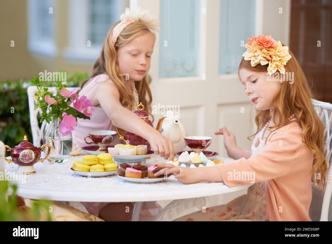 Children, friends and tea in garden for party at birthday for snack for ...
