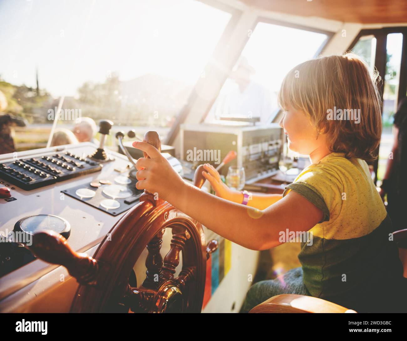Cute little boy pretending to a be captain, child steering a ship at ...