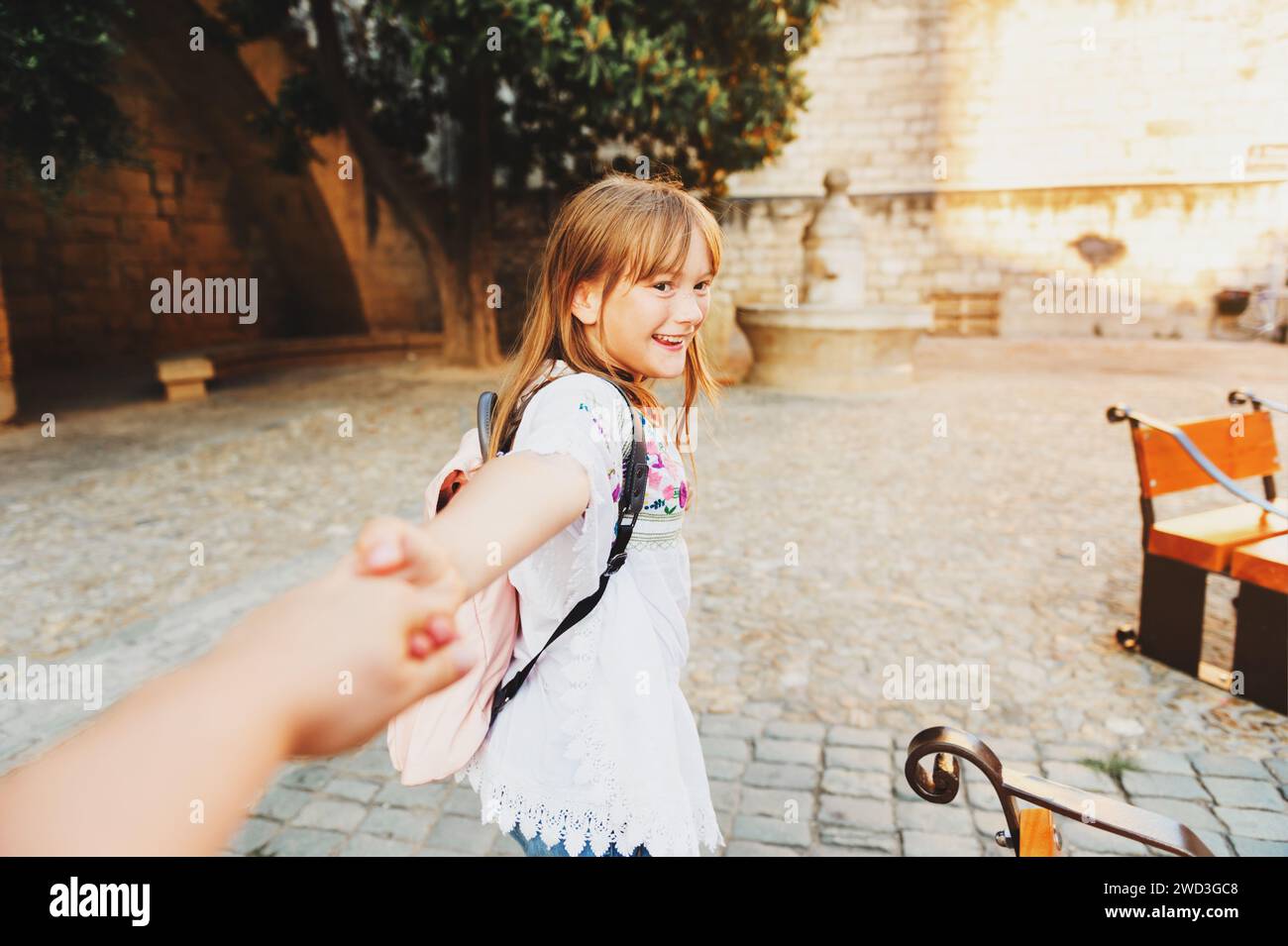 Adorable little girl tourist with backpack on the streets of Provence ...