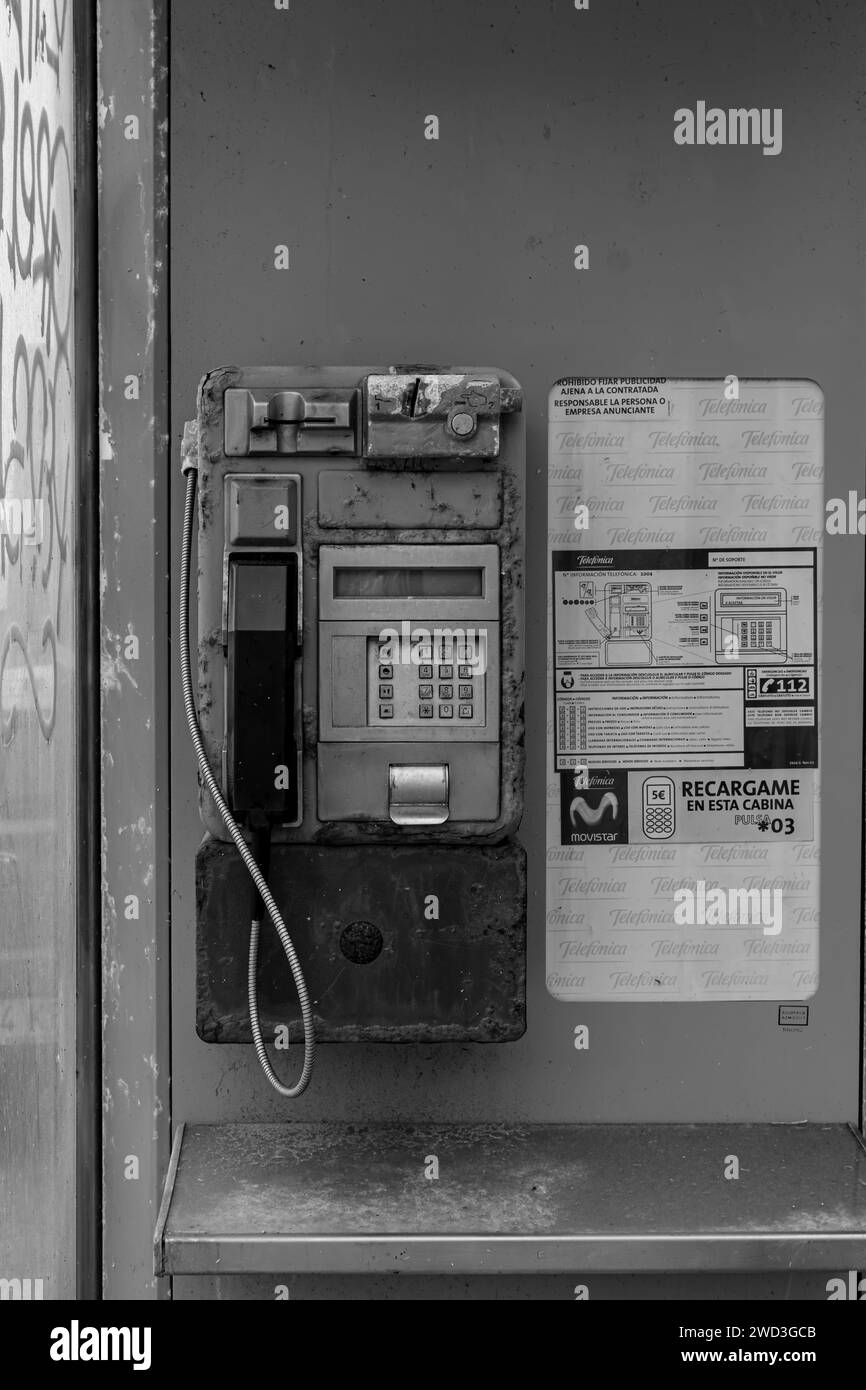 A booth with its old coin-operated telephone and the company sign and ...