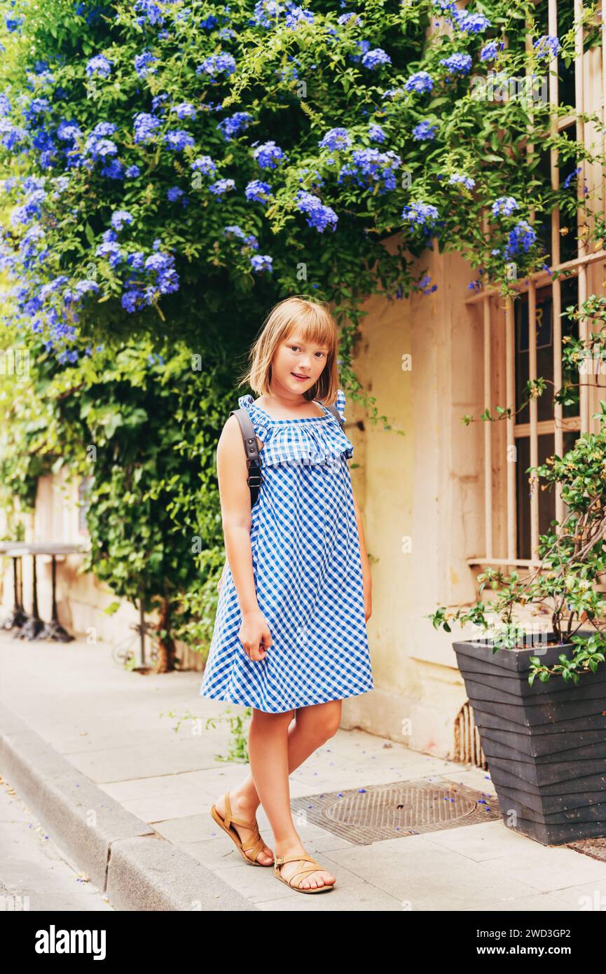 Pretty little girl tourist on the streets of Provence, Wearing blue ...