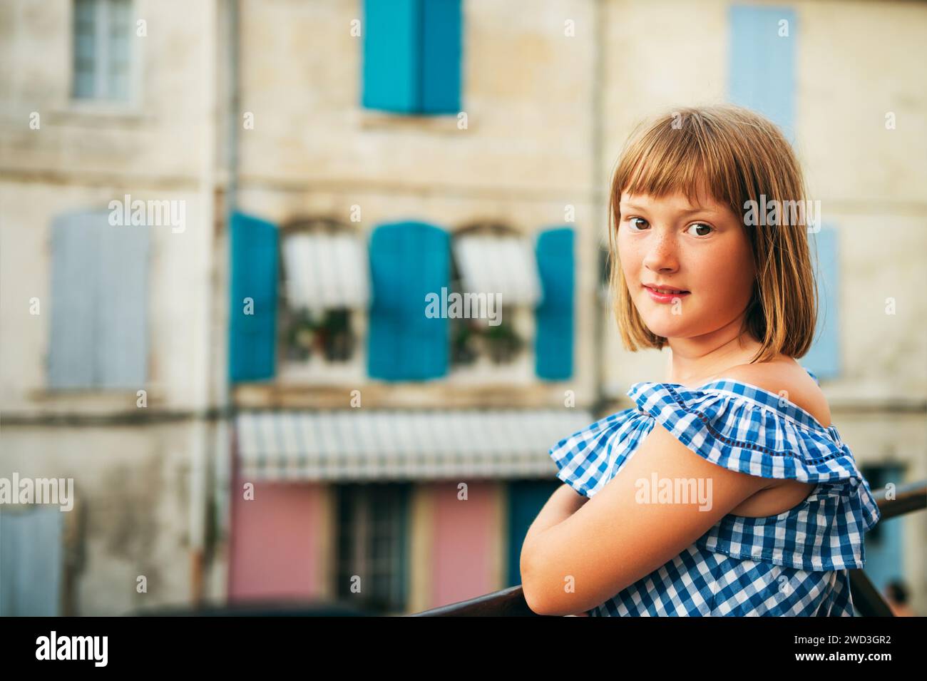 Portrait of adorable kid girl wearing blue gingham dress, posing ...
