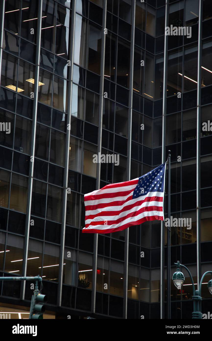 American Flag flying in the wind outside an office building in midtown ...