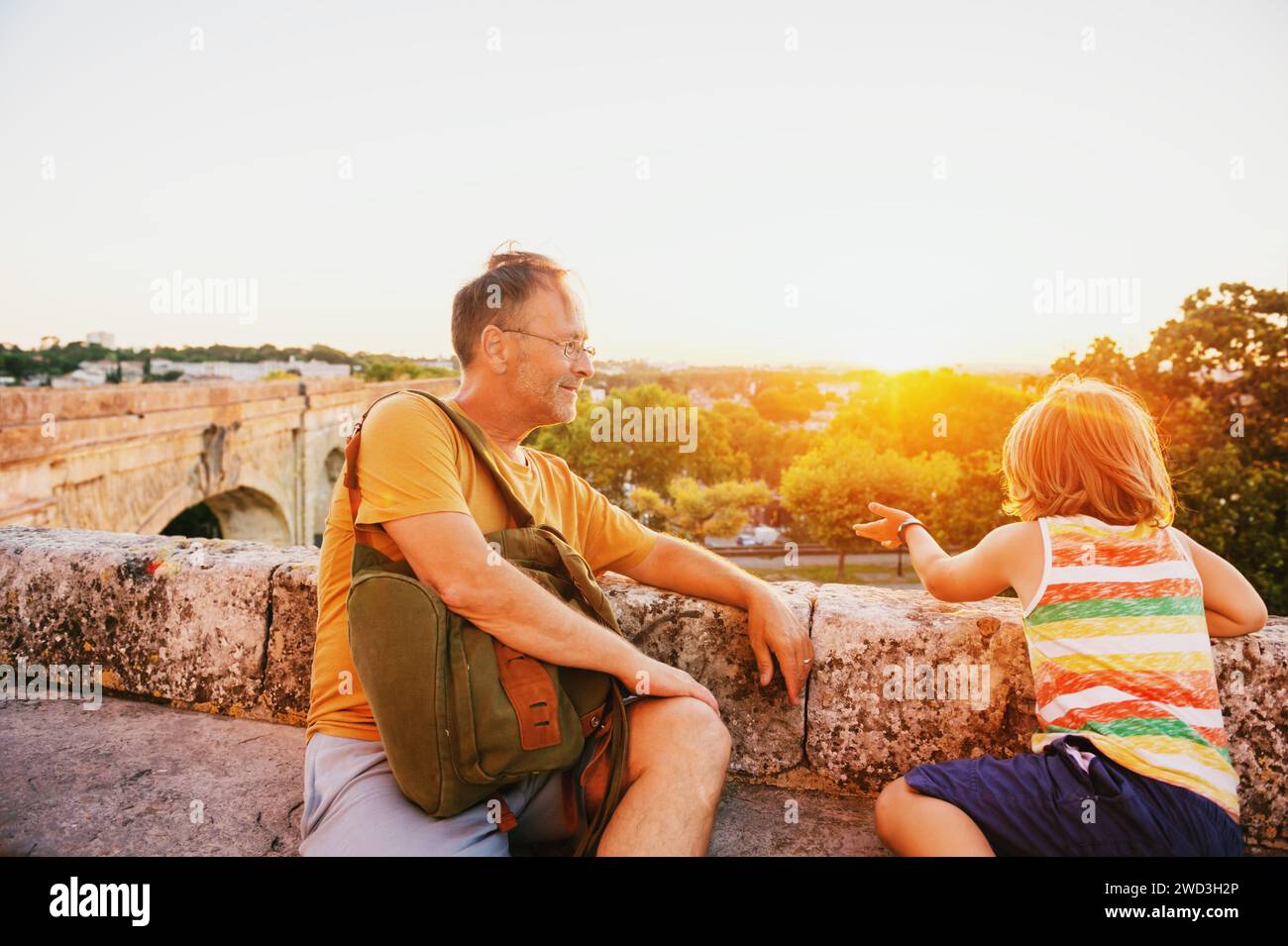 Happy tourists, father and son enjoying sunset at Saint Clement ...