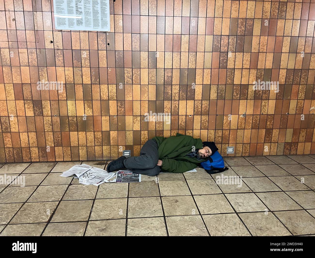 Homeless man takes shelter and sleeps in a New York City subway station ...