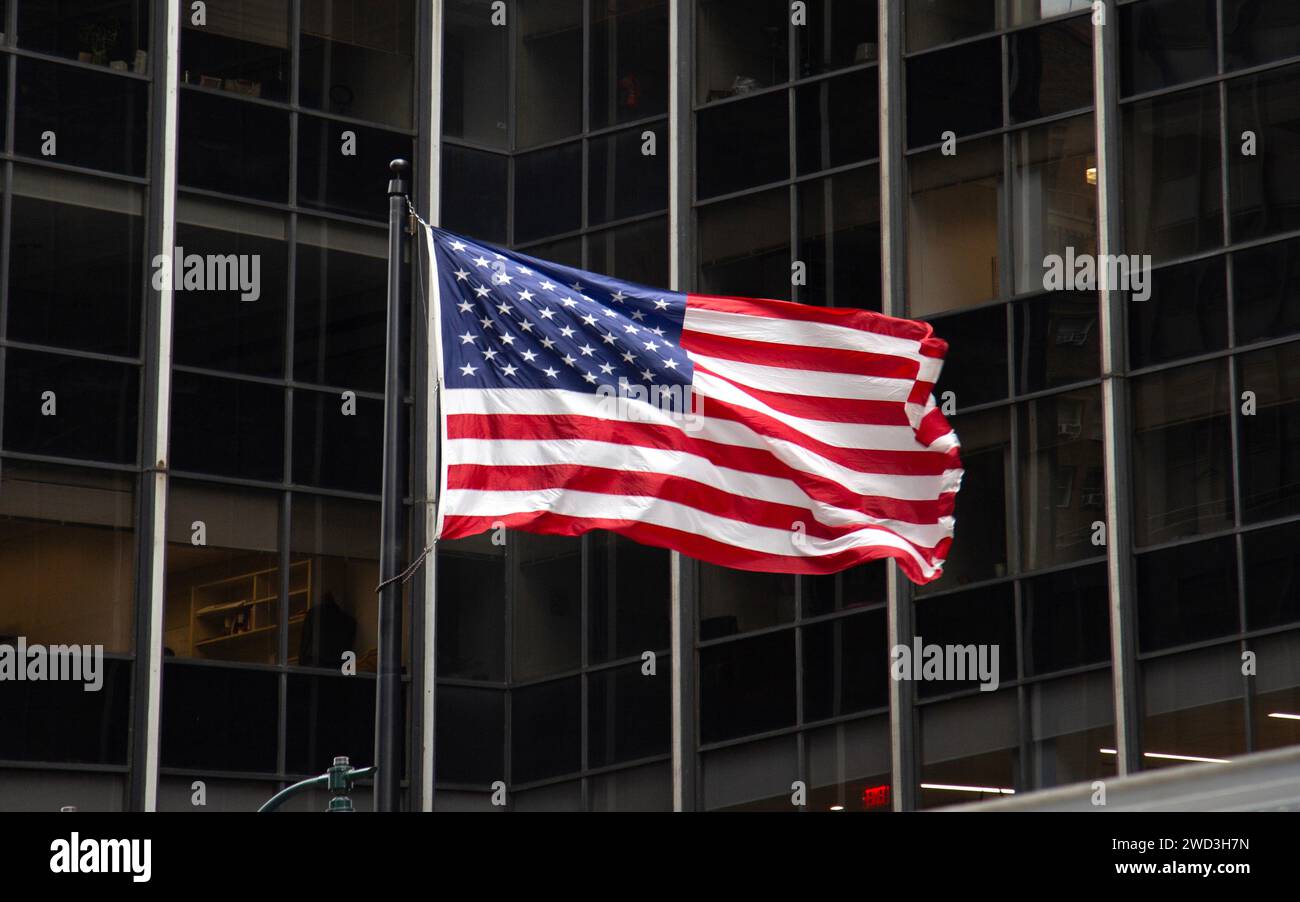 American Flag flying in the wind outside an office building in midtown ...