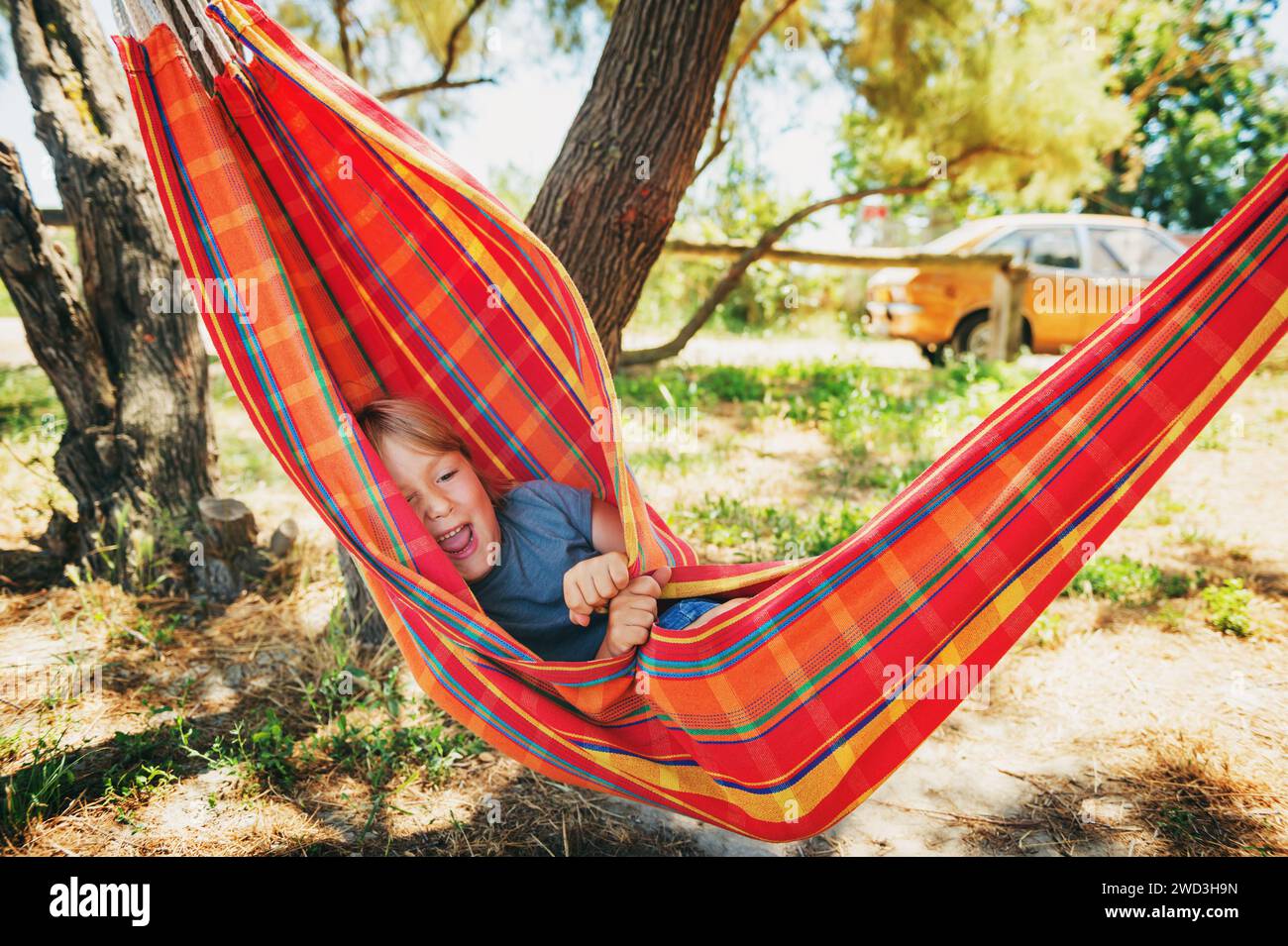 Funny little boy playing in hammock, child resting in garden Stock ...