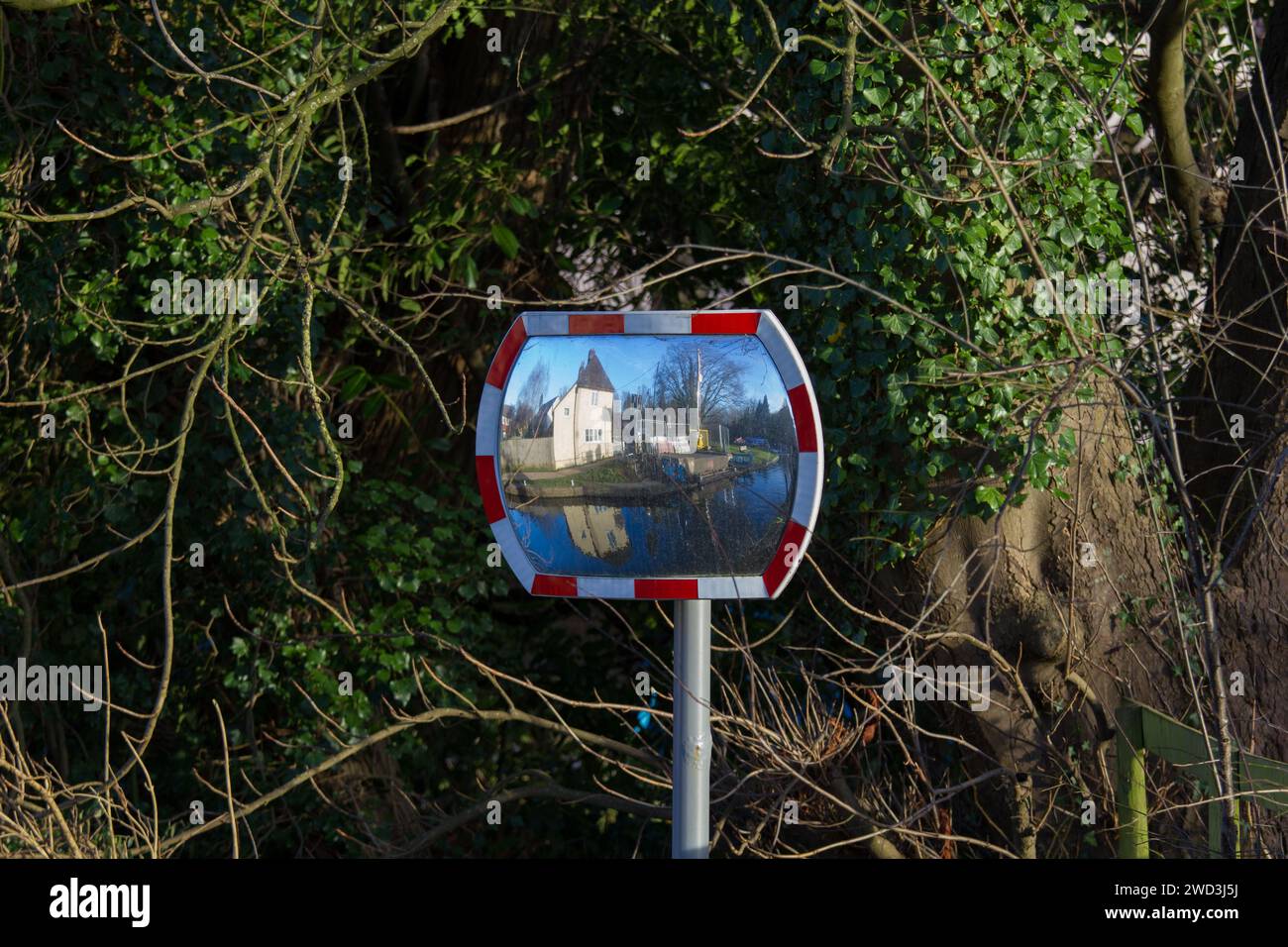 Canal traffic mirror at the Aldermaston Wharf canal bridge. Reflecting ...
