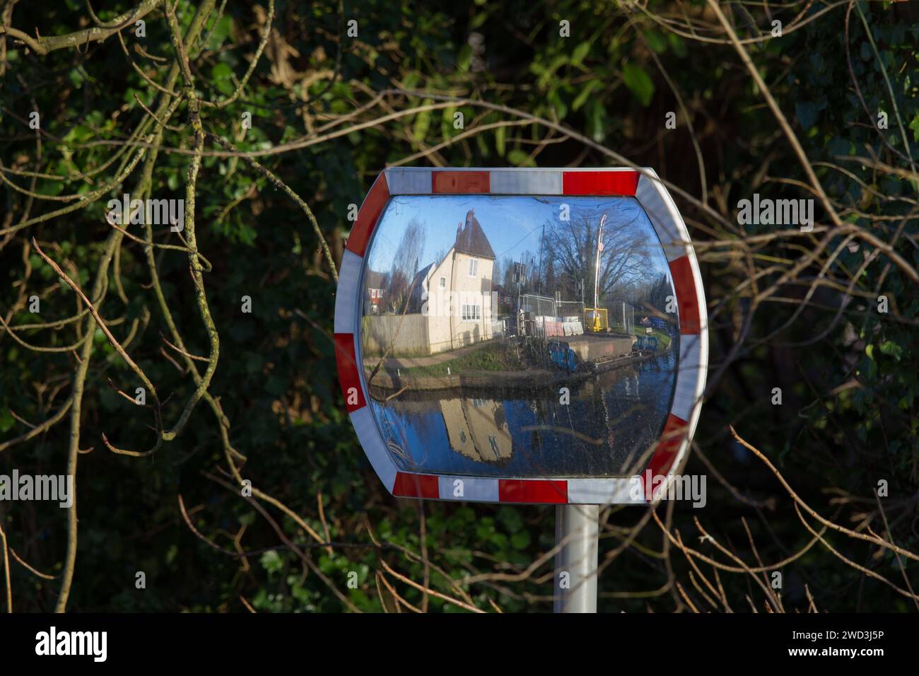 Canal traffic mirror at the Aldermaston Wharf canal bridge. Reflecting ...