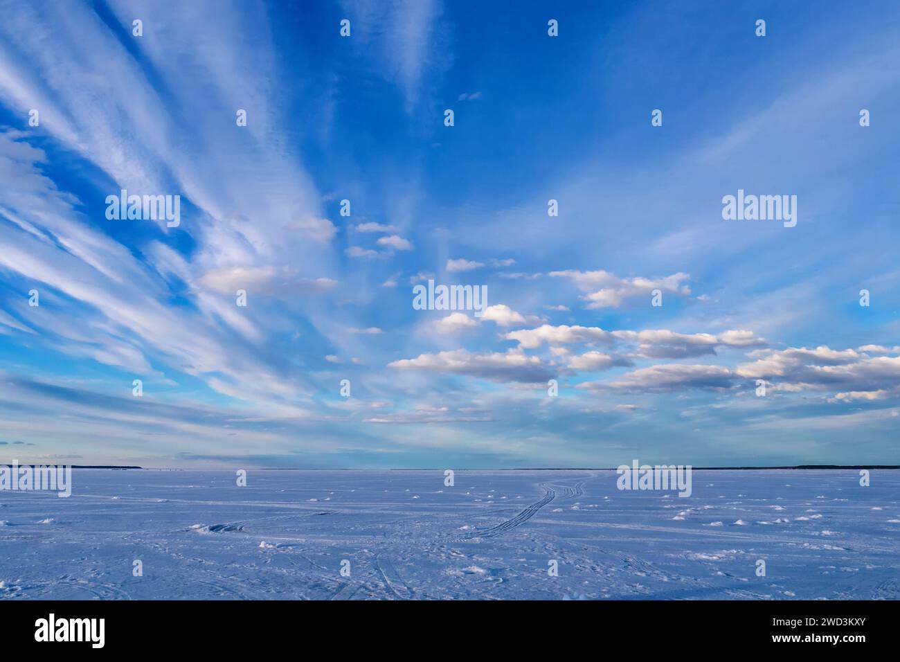 blue sky with white clouds on a winter day over the ice of the river ...