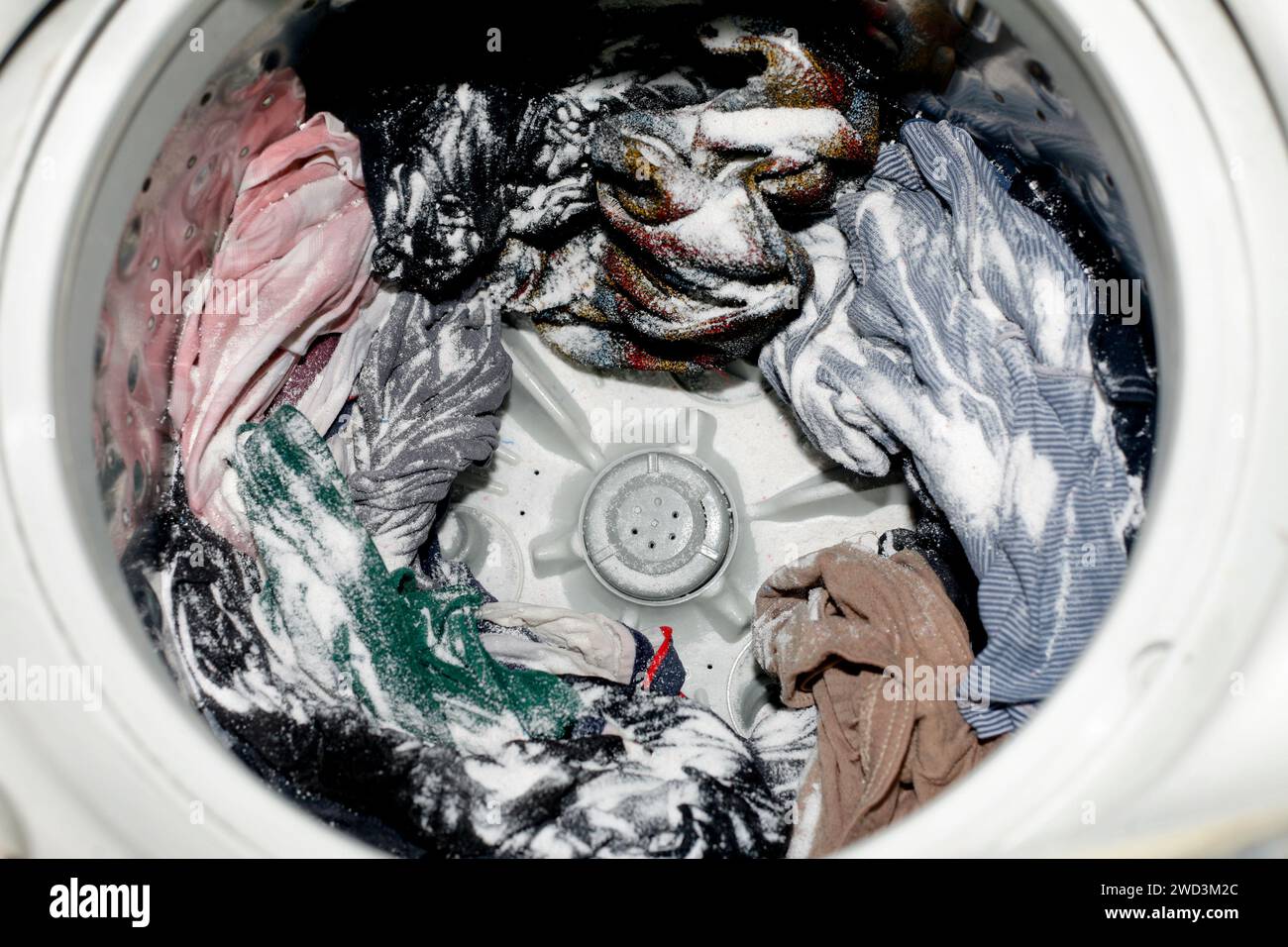 Dirty clothes with detergent powder inside washing machine Stock Photo ...