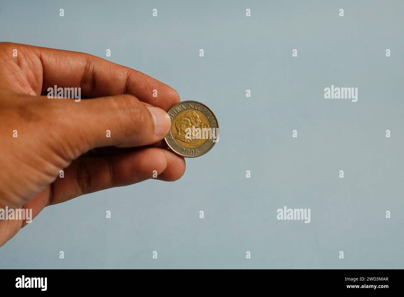 Close up hand holding ten piso coin philipines. Charity concept Stock ...