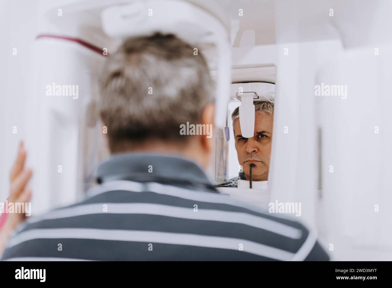 Elderly man in a modern dental clinic undergoing a 3D teeth scan for ...