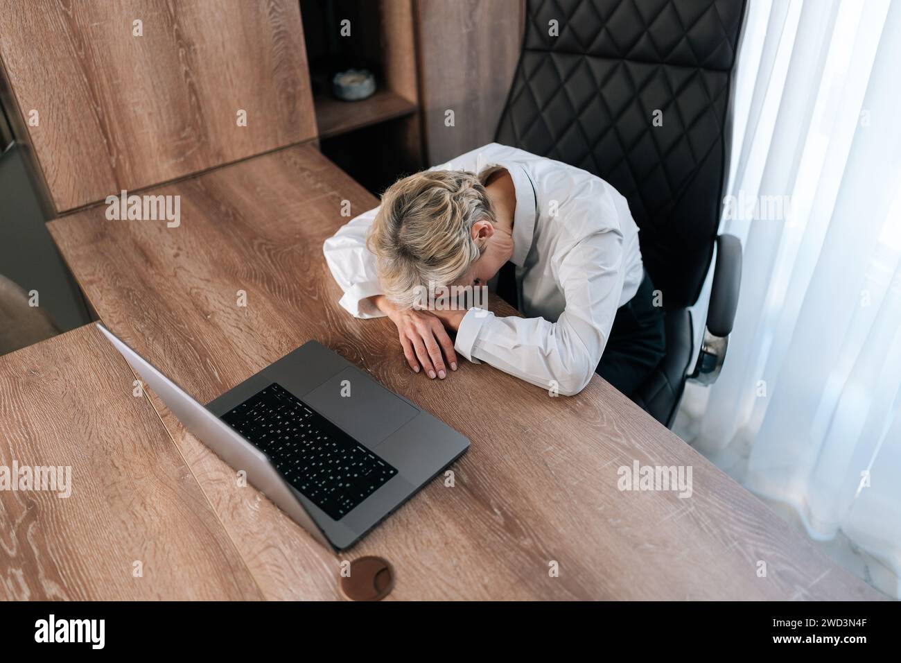 Top view of exhausted female entrepreneur fall asleep on desk ...