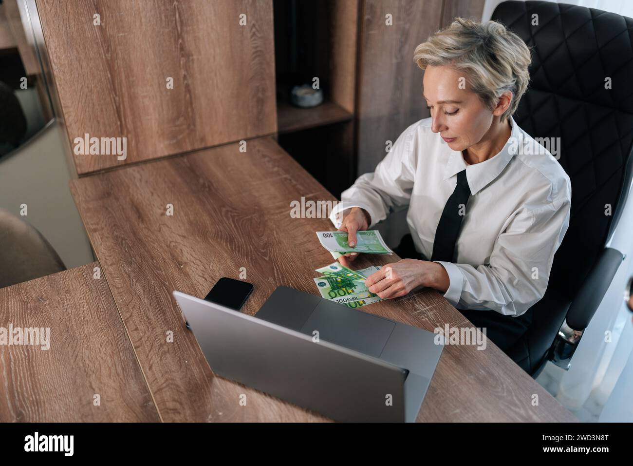 Top view of female count one hundred euro bills. Happy businesswoman ...