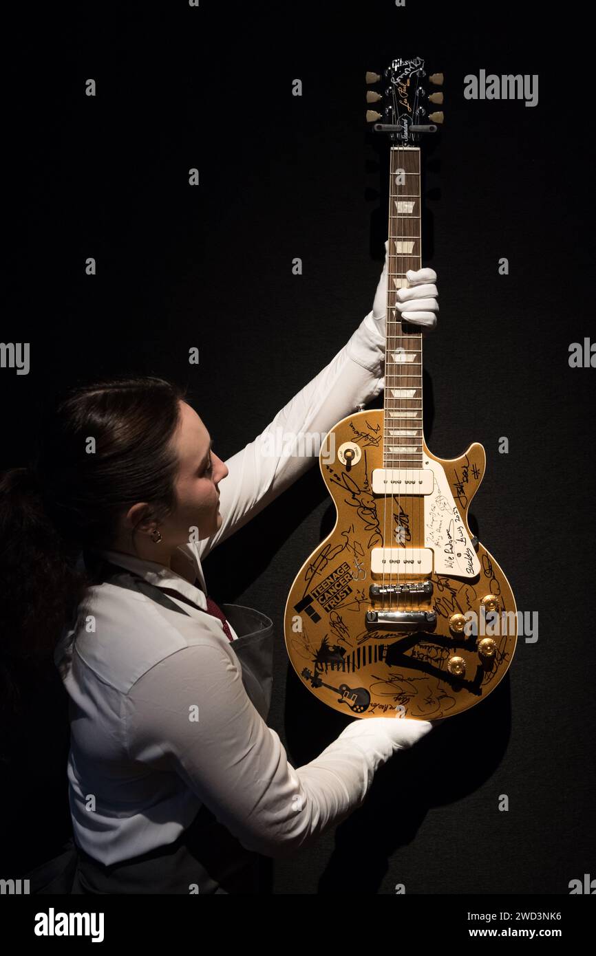 LONDON, UNITED KINGDOM - JANUARY 18, 2023: A staff member holds Gibson ...