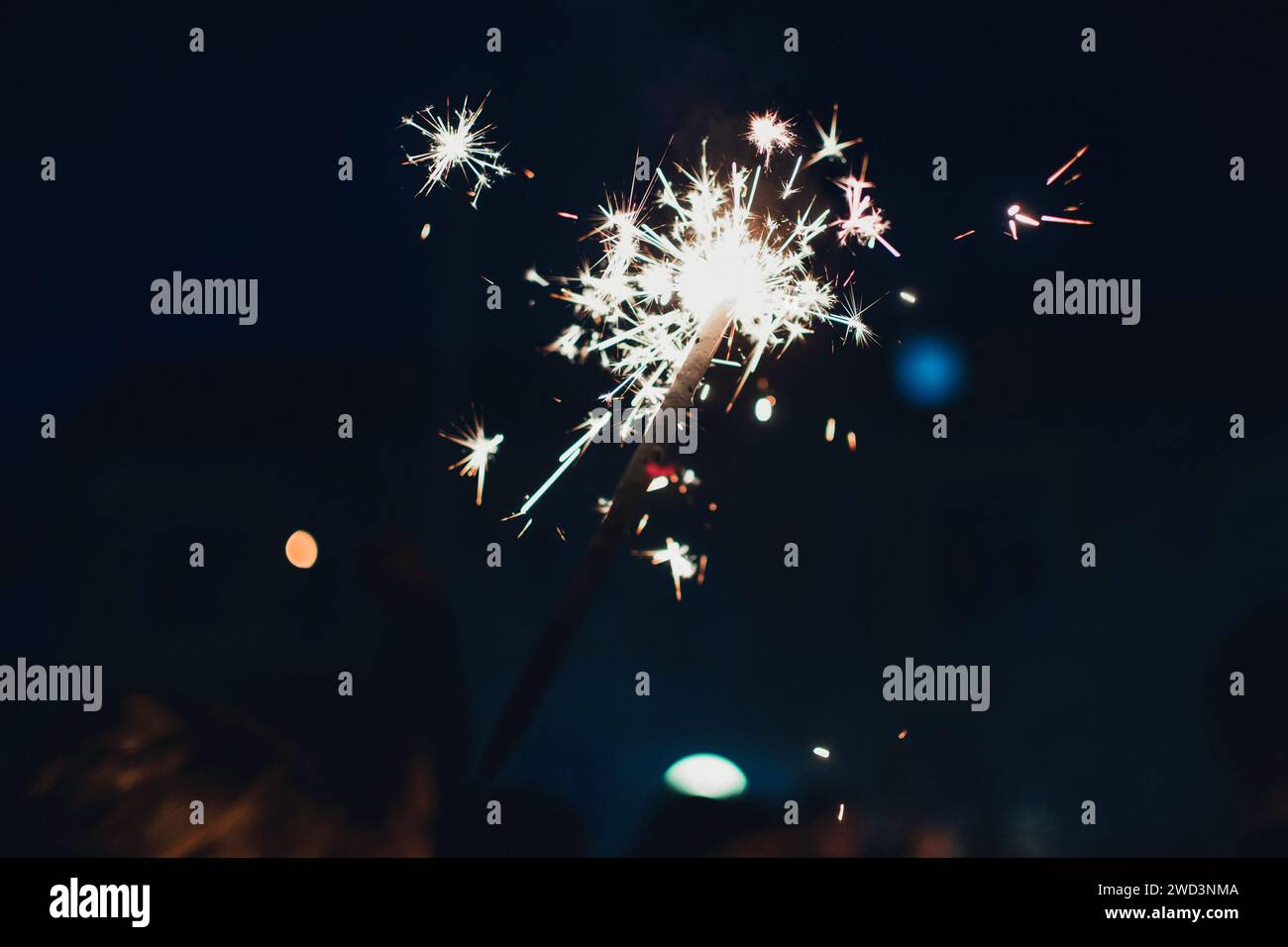 Bengali fire with sparks on dark background close up Stock Photo - Alamy