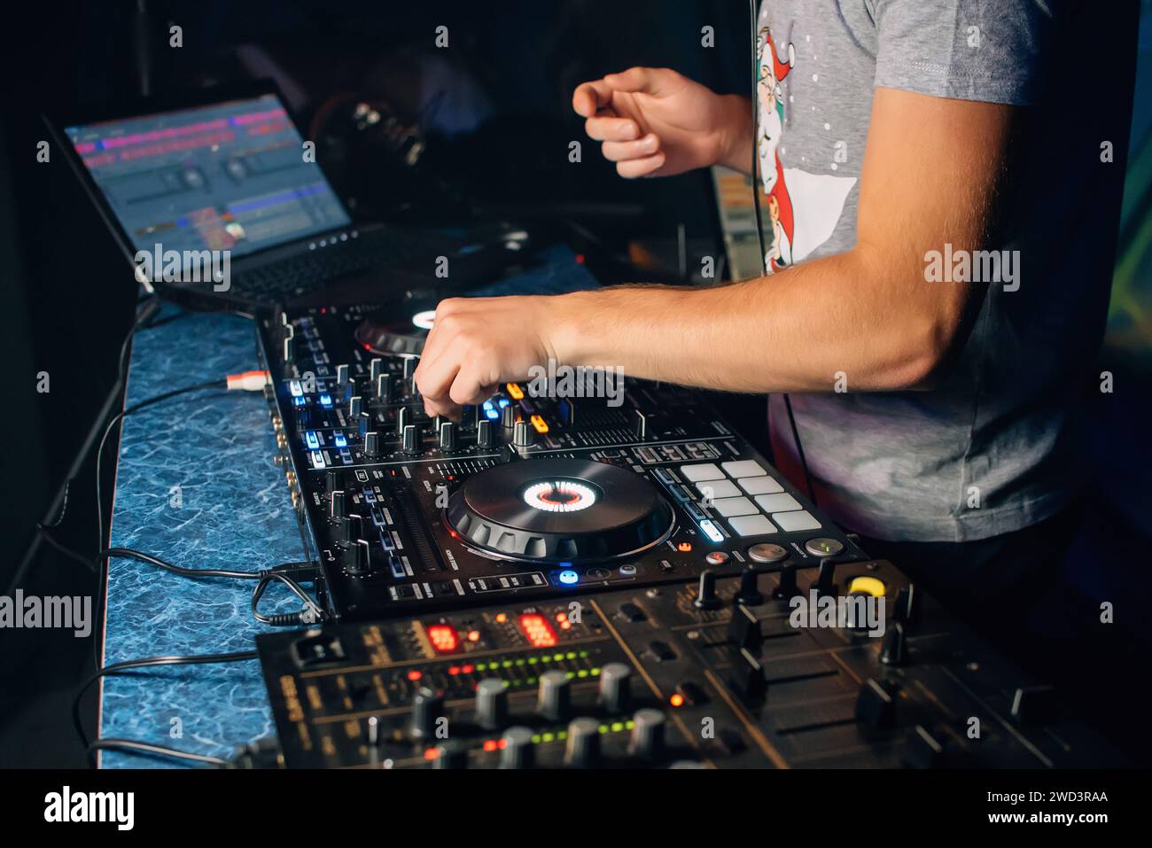 DJ plays with his hands on a music mixer in a nightclub Stock Photo - Alamy