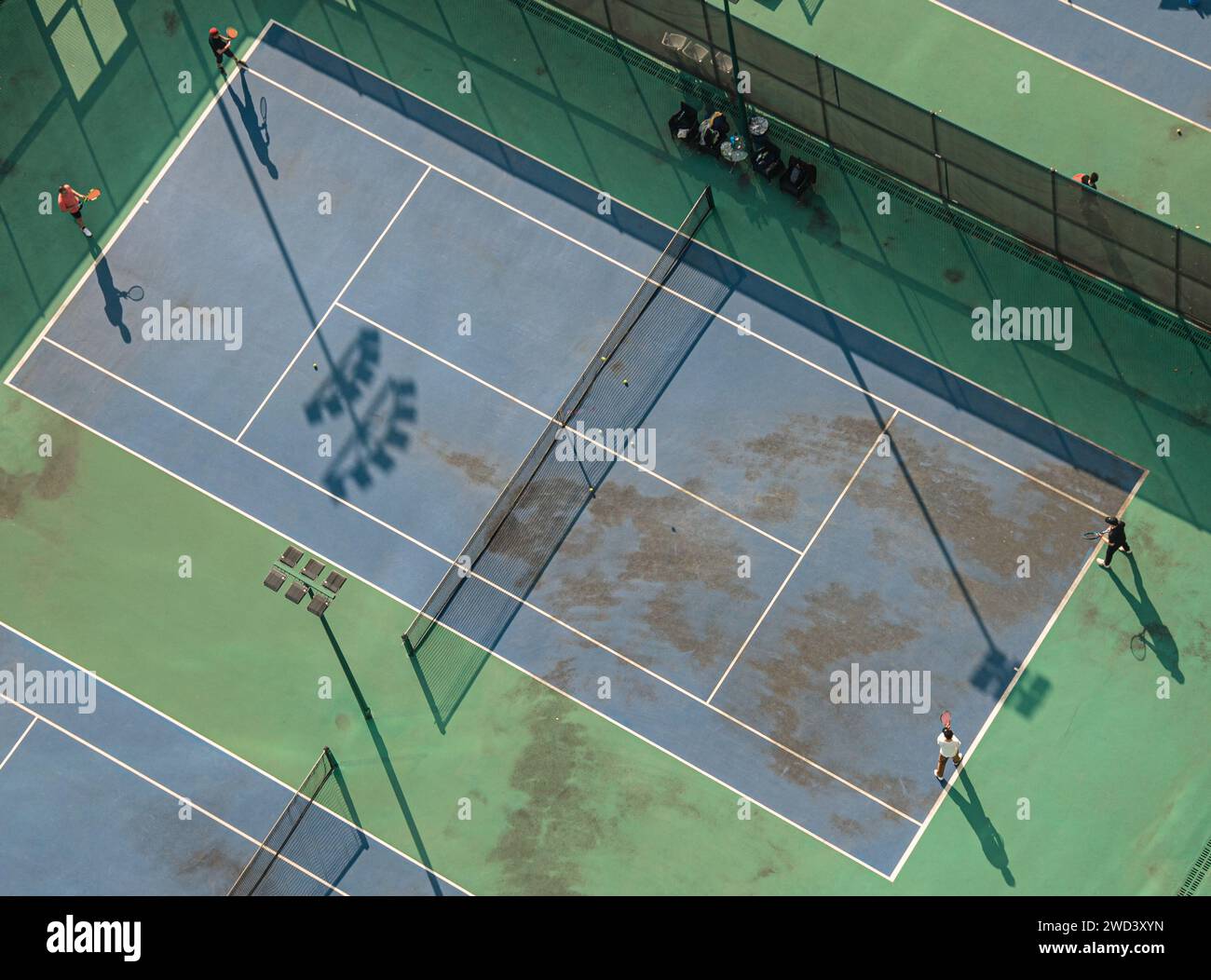 Aerial shot of tennis court with active youth Stock Photo - Alamy