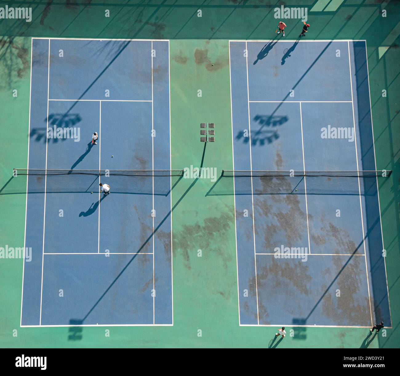 Aerial shot of tennis court with active youth Stock Photo - Alamy