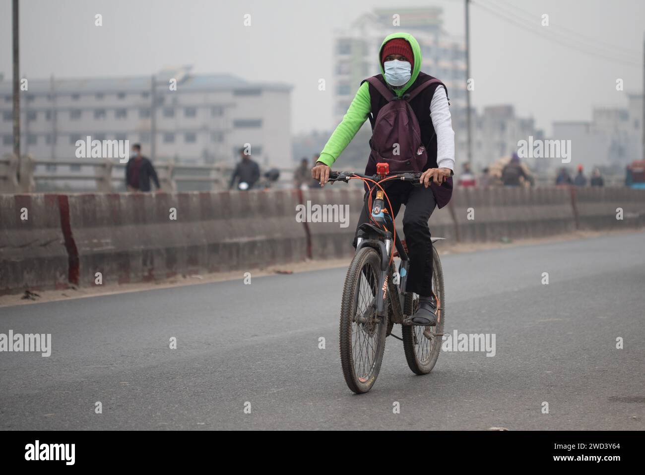 Dhaka, Dhaka, Bangladesh. 18th Jan, 2024. A man rides a bicycle to work ...