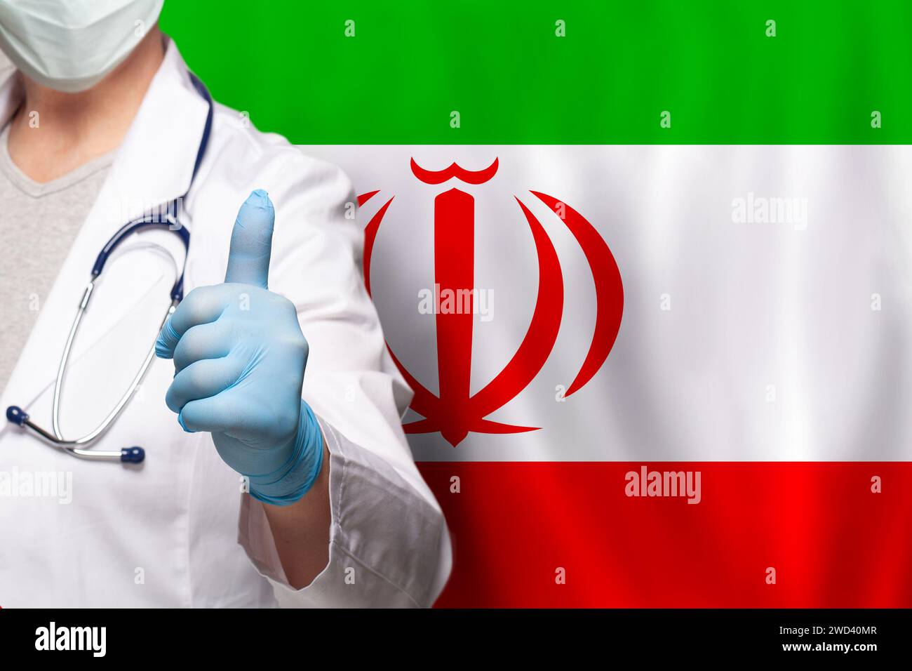 Irani doctor's hand showing thumb up positive gesture on flag of Iran ...