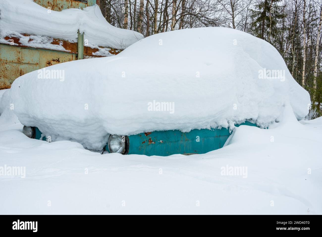 Car under the snow. A lot of snow after a snowfall. The car is ...