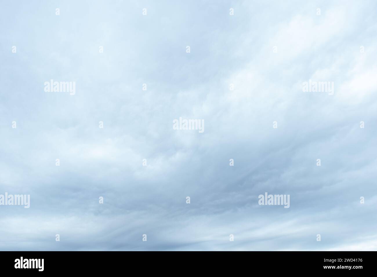 Dense gray thunderstorm cumulus wavy clouds in the whole frame. Gloomy ...