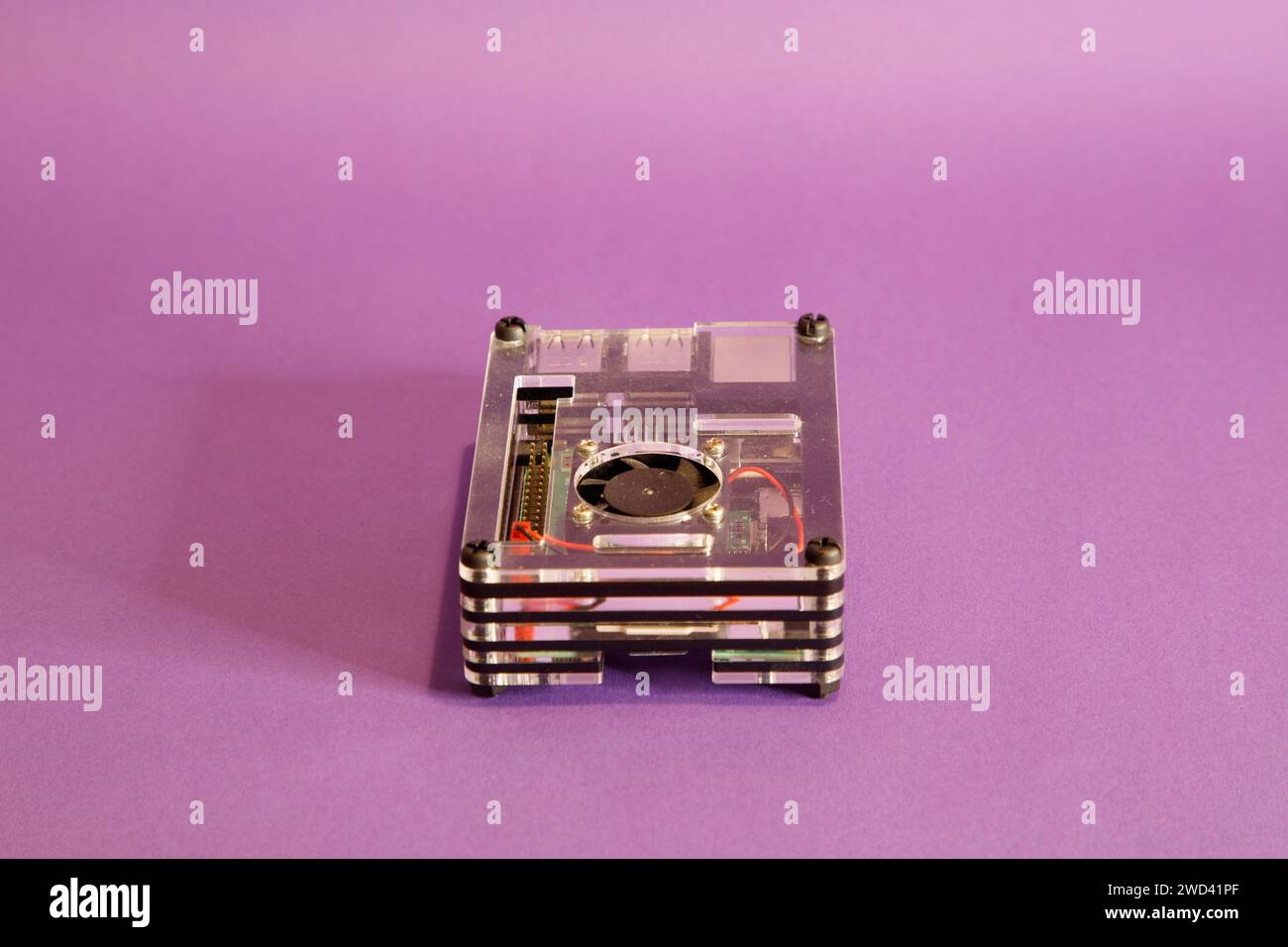 a Raspberry Pie 3 computer, on a mouve background, studio photography ...