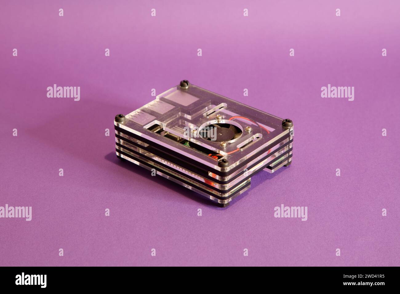 a Raspberry Pie 3 computer, on a mouve background, studio photography ...