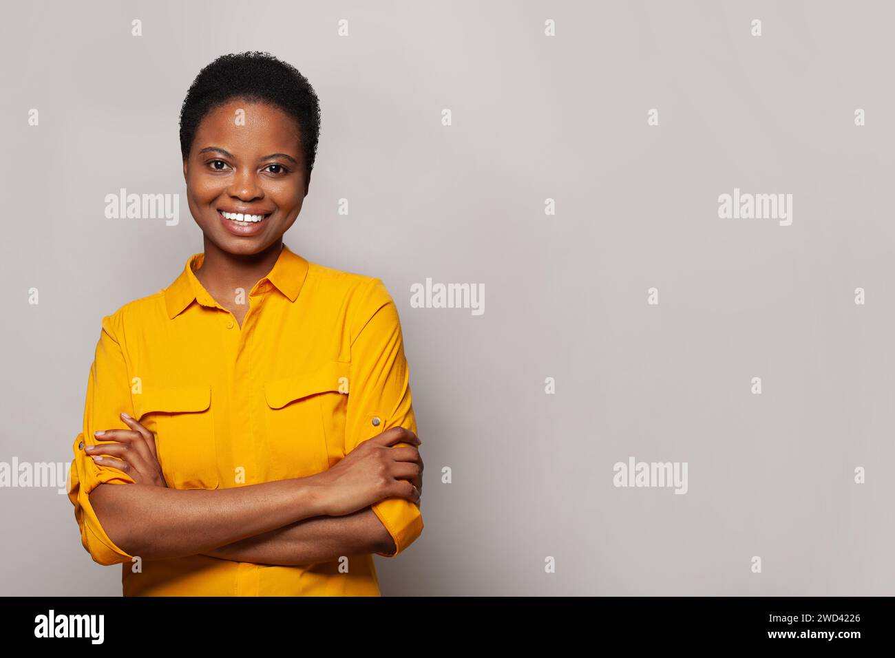 Successful happy woman smiling and having fun against white studio wall ...