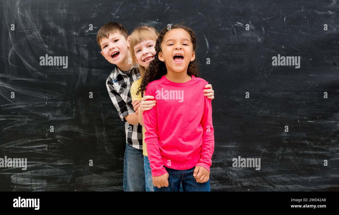 three different children stand one by one peeking out from behind each ...
