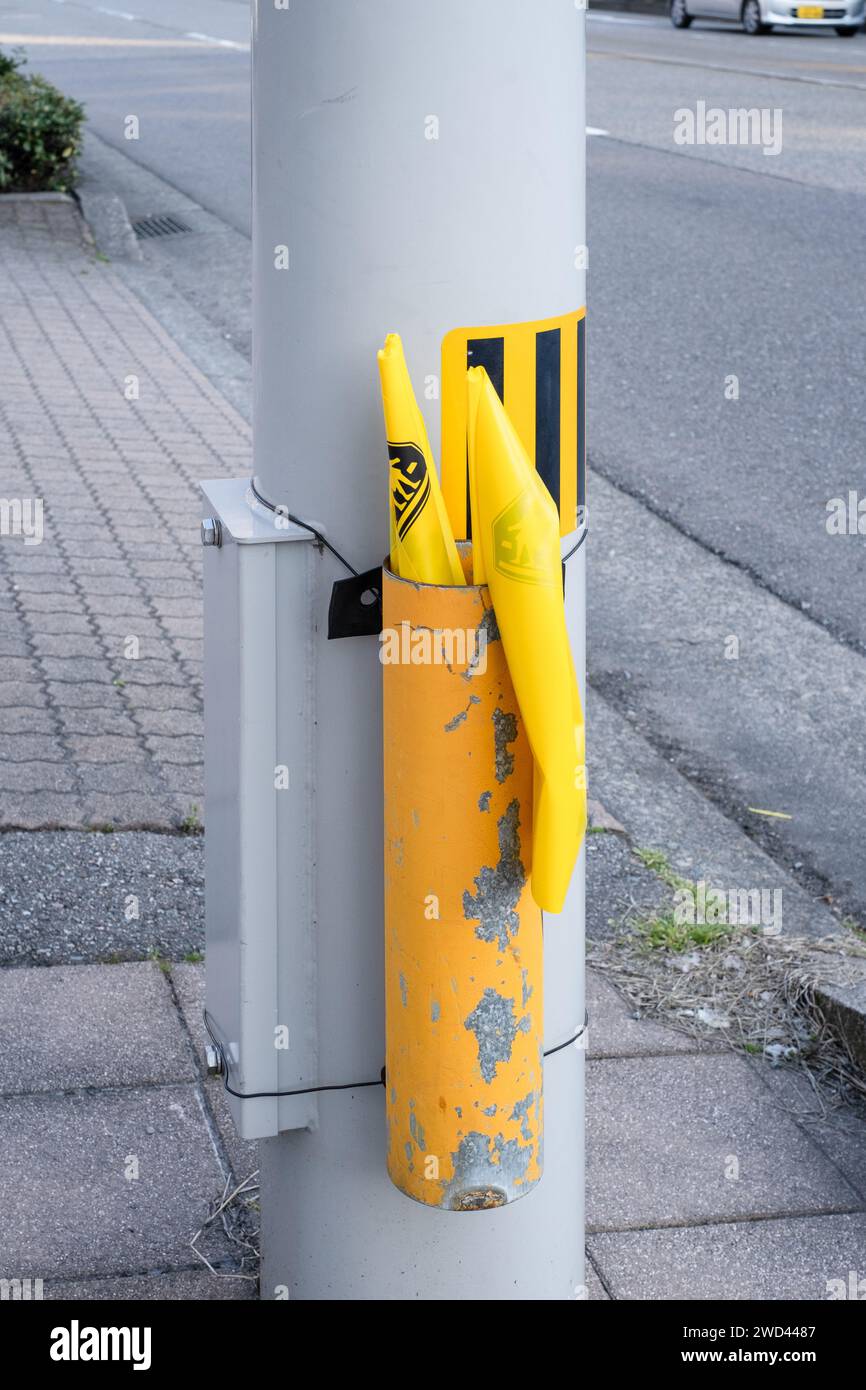 Flags at a pedestrian crossing in Kanazawa, Ishikawa District, Japan ...