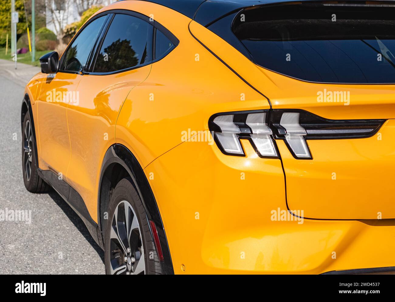 Yellow muscle car Ford Mustang. Headlights of yellow modern car. Back ...