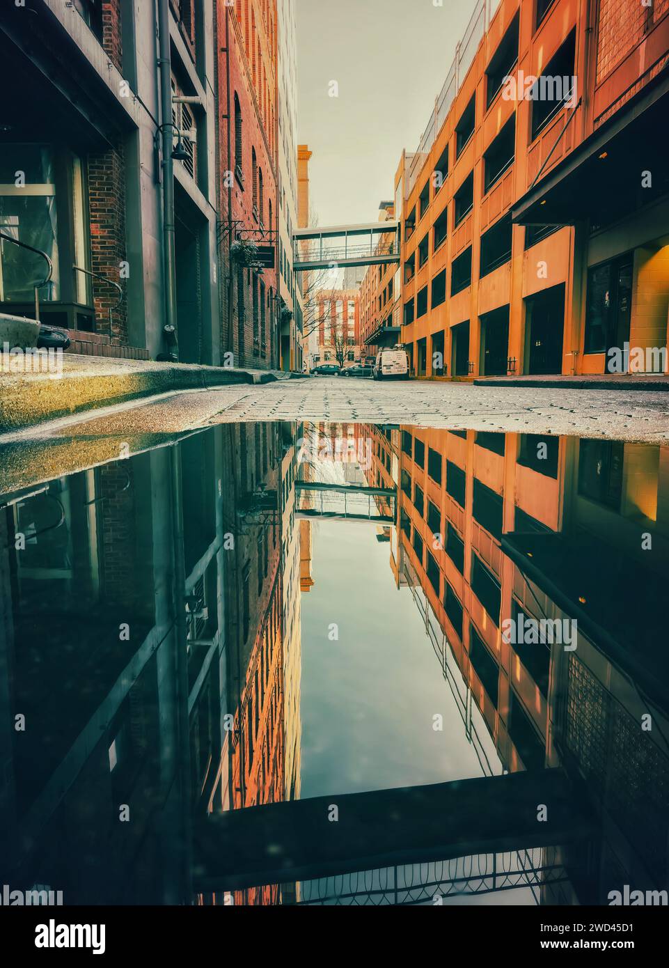 Puddle on alley street hi-res stock photography and images - Alamy
