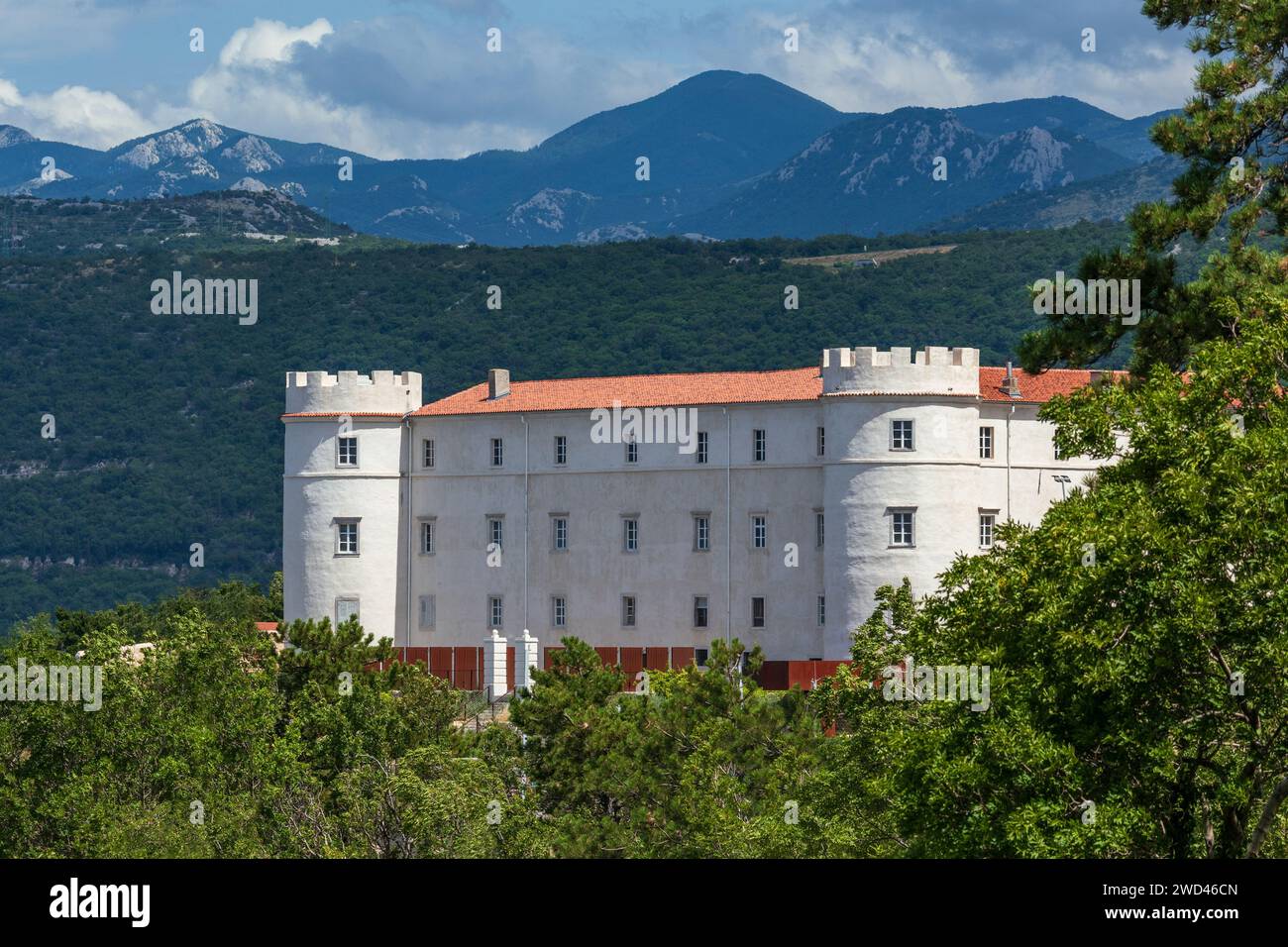 Beautiful Frankopan castle surrounded by lush greenery and Velebit ...