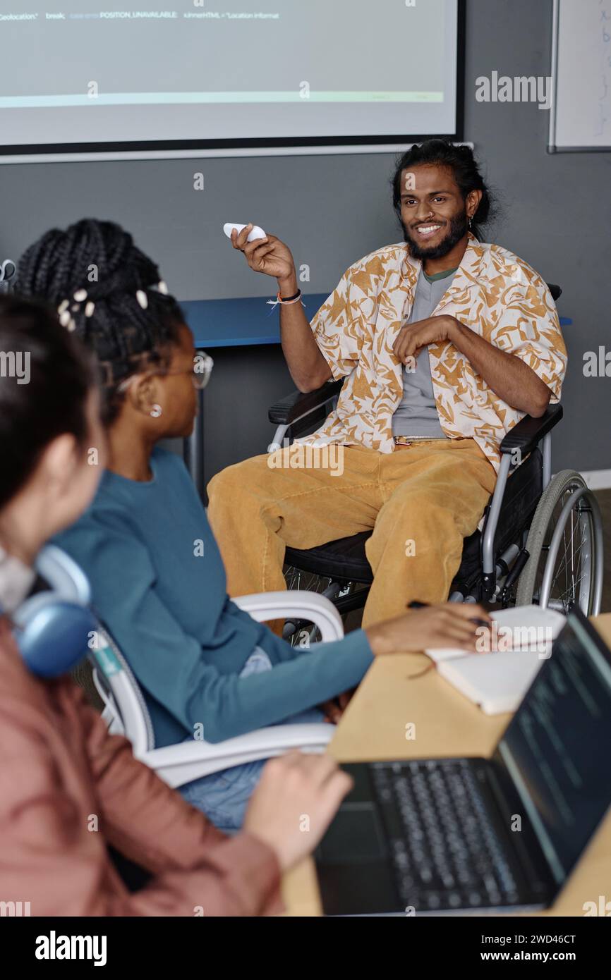 Man with disability in stylish outfit giving presentation to his ...
